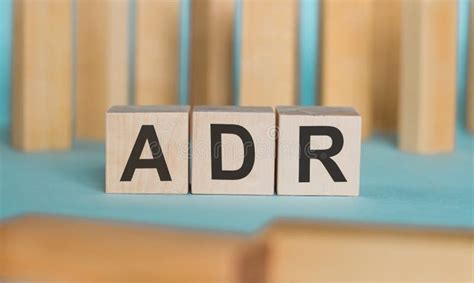 The Abbreviation ADR Adverse Drug Reaction Is Written On Wooden Blocks Against A Light Blue
