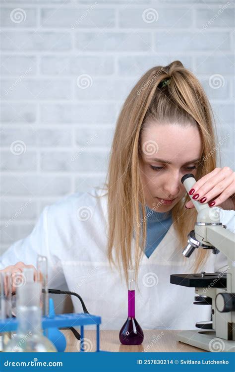 The Laboratory Assistant Examines Samples Of Materials Under A Microscope School Laboratory