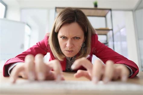 Aggressive Woman Types On Keyboard Of Computer In Office Stock Image