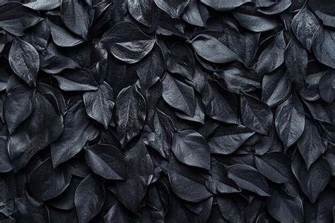 A Dark Background With A Texture Of Leaves And A Black Background Premium AI Generated Image