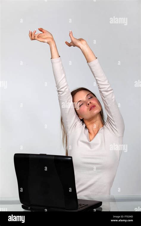 Woman With Laptop Stretching Stock Photo Alamy
