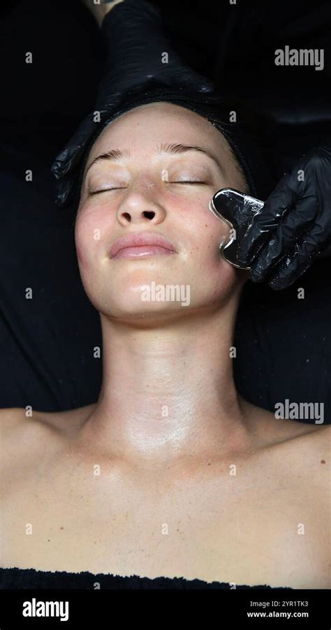 Woman Receiving A Gua Sha Facial Massage For Relaxation And Skin Stock