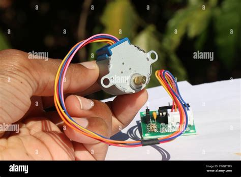 Stepper Motor Used In Various Hobby Electronics Projects Held In The Hand With Stepper Motor
