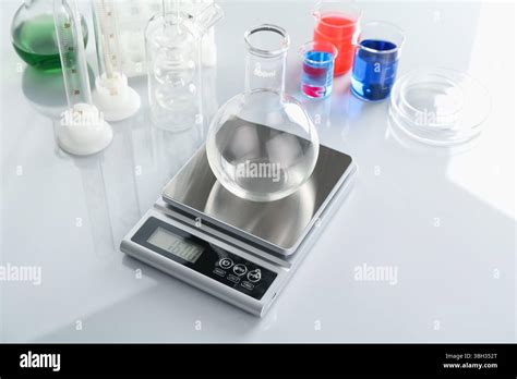 Scale With Empty Flask And Other Laboratory Glassware On White Mirror