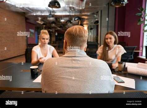 Group Of Architects Discussing Construction Drawings At Meeting Stock Photo Alamy