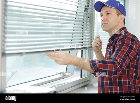 Man Installing Window Blinds At Home Stock Photo Alamy