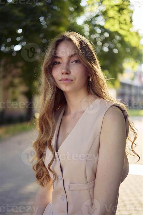 A Beautiful Teenage Girl In A Peach Fuzz Suit With A Waistcoat In The