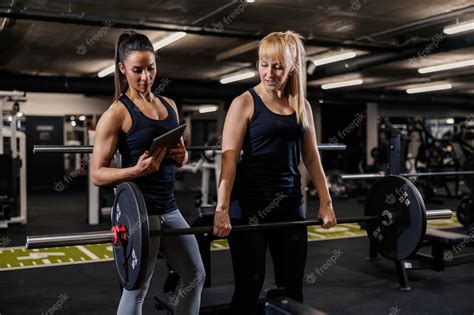 Premium Photo A Female Personal Trainer Is Tracking Progress On A