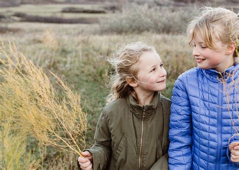 Young Sisters Playing Together Outside By Stocksy Contributor Carey