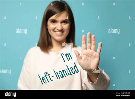 Left Handed Woman Against Light Blue Background Focus On Palm Stock Left Handed Woman Against Light Blue Background Focus On Palm Stock