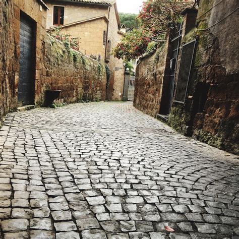 Cobblestone Street Amidst Buildings Premium Photo