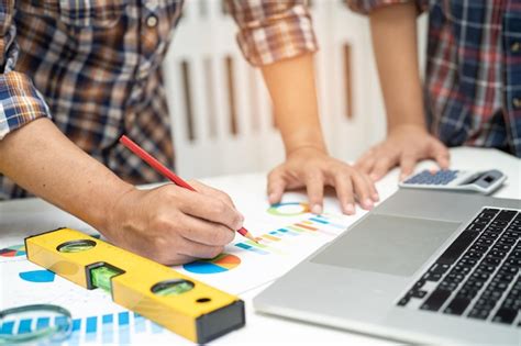 Premium Photo Asian Engineer And Partner Team Learn And Talk With House Plan Project Blueprint