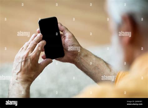 Smartphone With Black Empty Screen In Mature Man Hand Mockup Stock