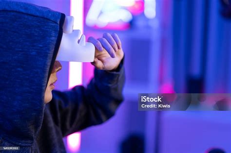 Short Of Computer Hacker Wearing White Mask Stealing Data From A Laptop Masked Hacker Using