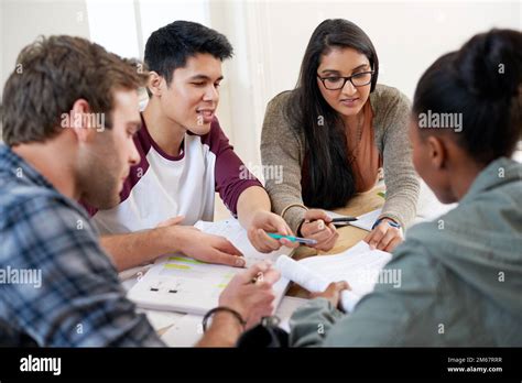 Working On Their Group Assignment A Group Of University Students In A