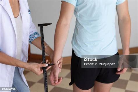 여성 영양사이자 병원에서 인체 측정 도구로 십대 환자의 팔 길이를 측정하는 의료 상담 중 인체측정학에 대한 스톡 사진 및 기타