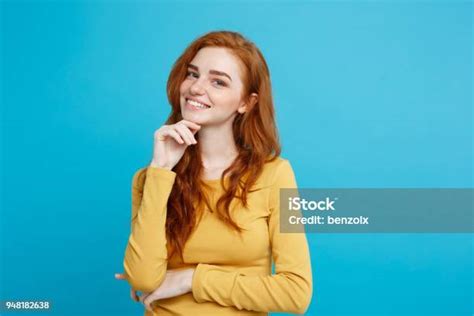 라이프 스타일 개념수줍음과 그녀의 머리와 재생 세로 젊은 아름 다운 매력적인 생강 빨간 머리 여자를 가까이 블루 파스텔 배경입니다 공간에 복사 합니다 귀여운에 대한 스톡