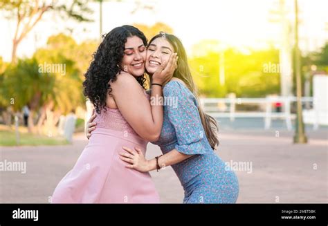 Two Female Friends Hugging In Front Outdoors Girl Friends Hugging And