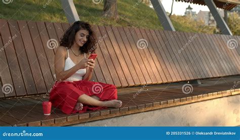 Cheerful Woman With Barefoot Using Smartphone While Chatting In Social
