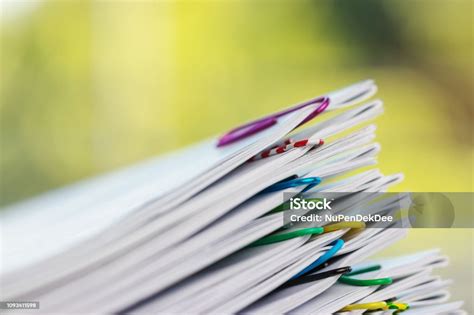 Close Up Pile Of Unfinished Homework Assignment Stacked In Archive With