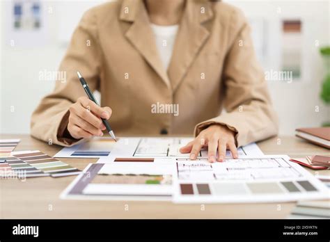 Architecture Concept Female Architect Selecting Color And Designing House Interior In Blueprint