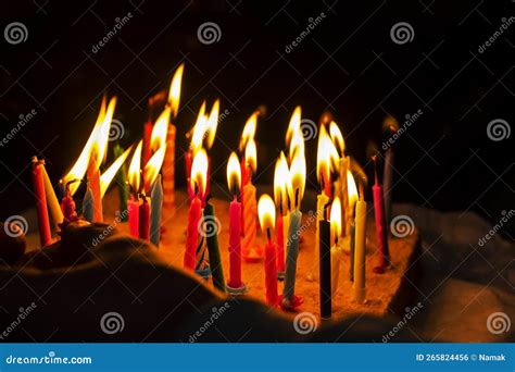 Light A Lot Of Multi Colored Candles On A Festive Anniversary Cake In