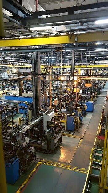 Panoramic Image Of A Busy Factory Floor Capturing The Machinery Layout