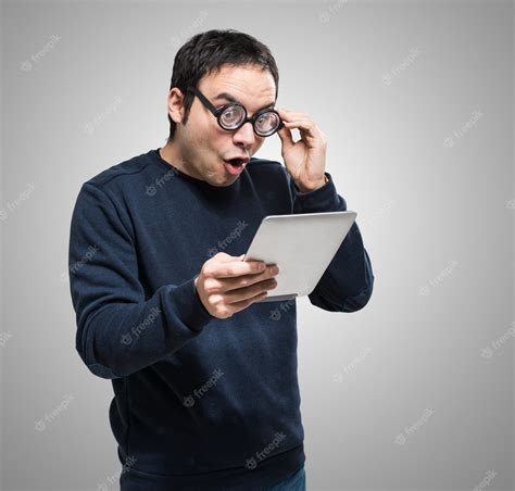 Premium Photo Portrait Of A Surprised Nerd Looking At His Digital Tablet