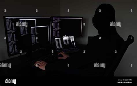 Hacker In The Dark Working On Multiple Devices Stock Photo Alamy