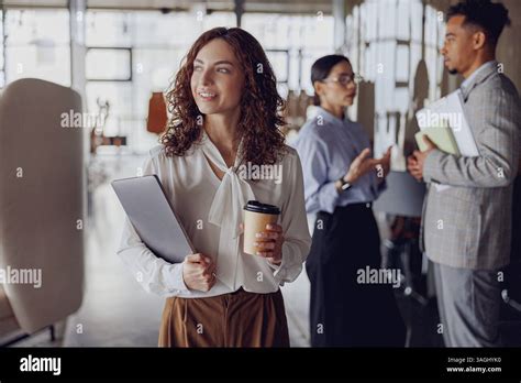 Engaging In Professional Networking Activities Within A Modern Office Environment Setting Stock