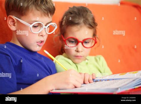 Girl And Boy Intently Doing Homework Focus On The Hinge Glasses Stock