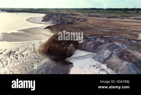 Phosphate Mining Site In Florida With Large Pipe Ejecting Water And Sand Slurry During Mineral