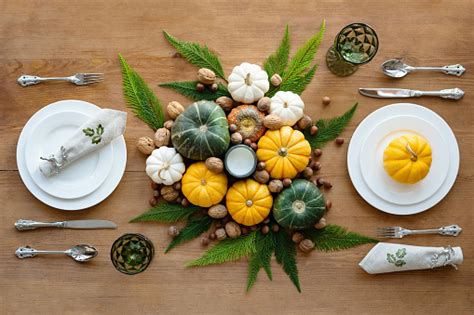 추수 감사절을위한 2 인용 세트 테이블 접시 와인 잔 칼 붙이 및 나무 테이블에 셀카 호박 견과류 양초 및 주니퍼 탑 뷰의 테이블 장식 추수감사절에 대한 스톡 사진 및 기타