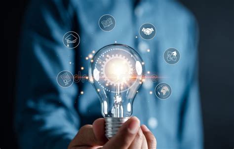 Man Hand Holding Lightbulb With Learning Educate And Graduation Concept