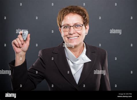 Business Senior Lady Holding Stapler And Smiling On Black Background
