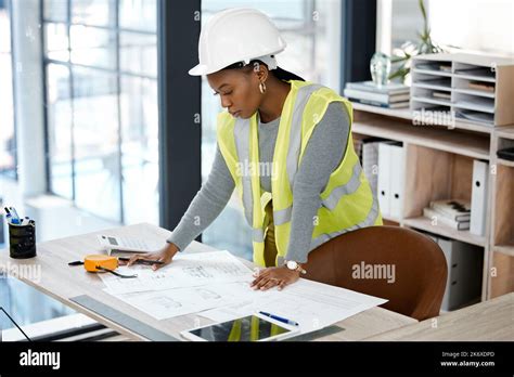 Making The Necessary Changes A Female Engineer Drawing Up Blueprints Stock Photo Alamy