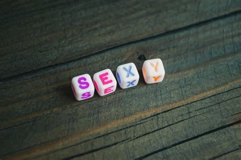 Premium Photo The Sexy Inscription Is Laid Out Of Cubes On A Wooden Table The Inscription For