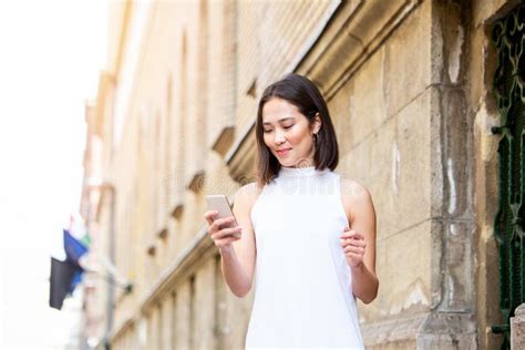 beautiful asian woman using an application to send an sms message in