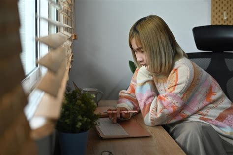 Premium Photo Side View Asian Woman Surfing Internet With Computer Laptop In Living Room