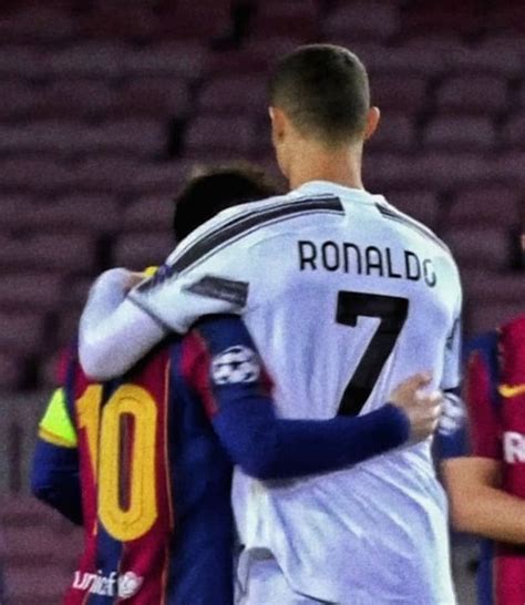 Messi And Ronaldo Hugging Wallpaper A Symbol Of Sportsmanship