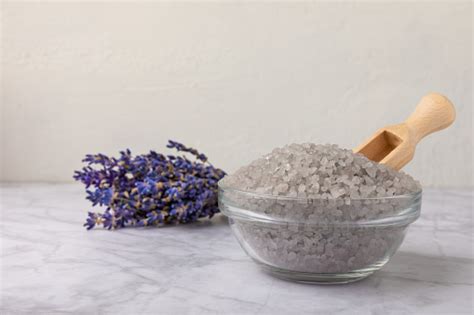 라벤더 꽃과 향기로운 바다 소금 스파 미용 및 건강 살롱 스킨 케어 화장품의 개념 천연 화장품 아로마 절차 흰색 나무 배경에 사진을 닫습니다 건강관리와 의술에 대한 스톡