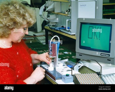 Headphone Testing Woman Using A Computer Aided Device To Test The Functionality Of Components