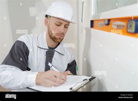 Builder Writing Down Construction Results Stock Photo Alamy
