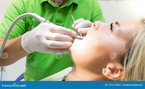 Closeup Image Of Dentist Removing Caries From Woman`s Teeth With