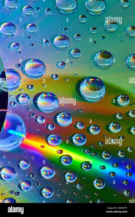 Laser Burst Of Rainbow Light Across Reflective Metallic Surface With Shimmering Bubbles Asset