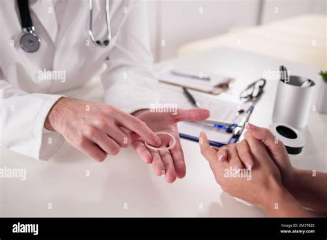 Gynecologist Showing Contraception Ring To Woman And Explaining Birth