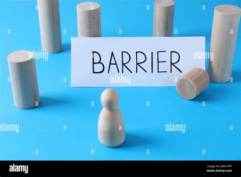 Blocks As Barrier Blocking Way For Wooden Human Figure On Light Blue Background Development