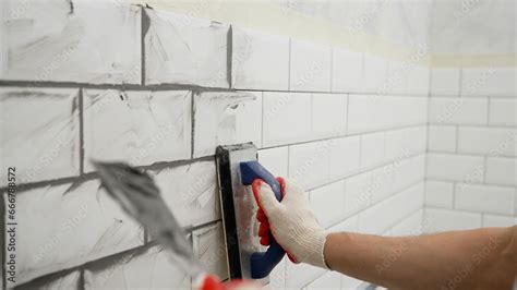 Working Grouting Of Tiles Applying Grout To The Seam Of Tiles For Home