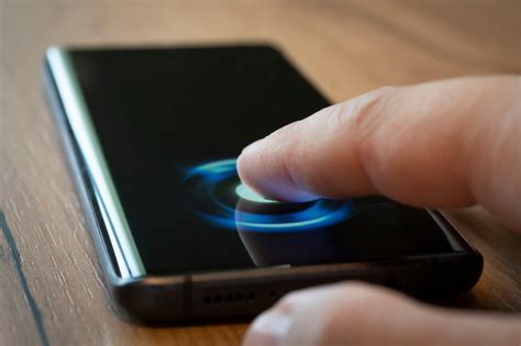 Premium Photo Male Finger Presses On The Smartphone Screen To Unlock By Fingerprint Closeup