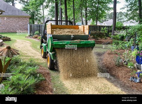 John Deere 4x2 Gator Being Used To Sand Or Top Dress A Residential Yard